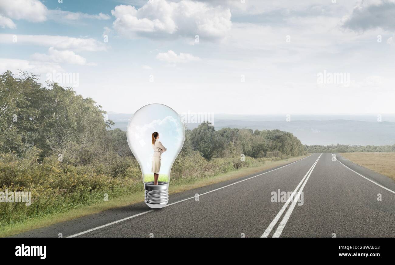 Businesswoman inside light bulb Stock Photo - Alamy