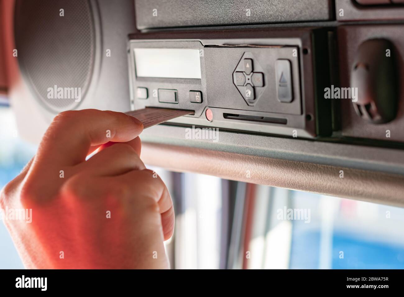 Truck driver performing driver card and menu operations on the ...