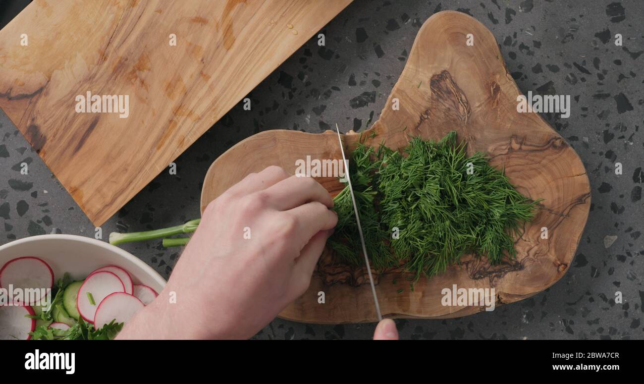Top view man hands chop fresh dill on concrete countertop Stock Photo ...