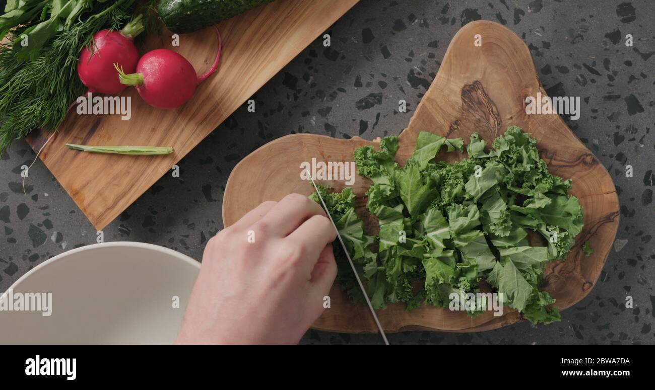 Top view man hands cut kale leaves on concrete countertop Stock Photo ...