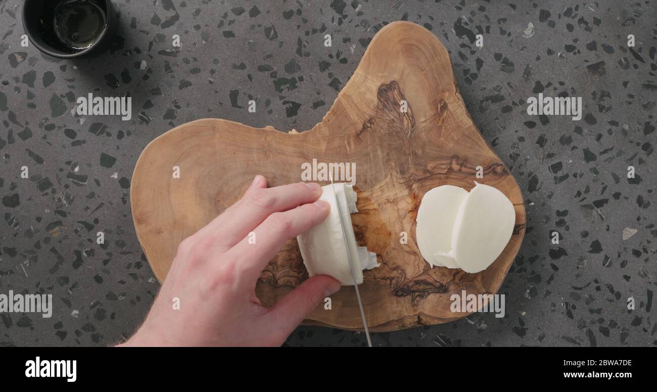 Top view man hands cutting mozzarella on concrete countertop Stock ...