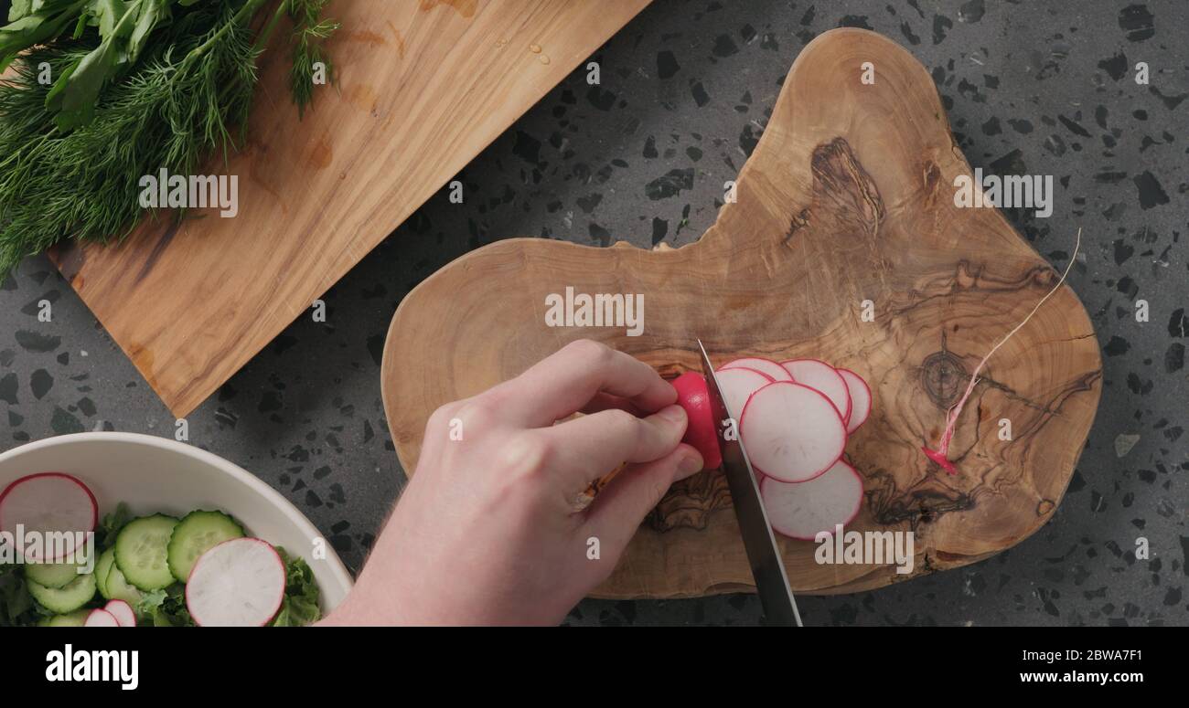 Top view man hands cutting fresh radish on concrete countertop Stock ...