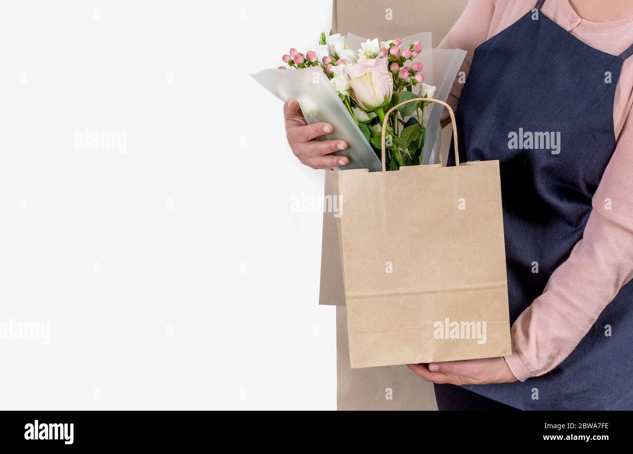 Female Worker of Delivery Service in Uniform Packing Flowers in paper ...
