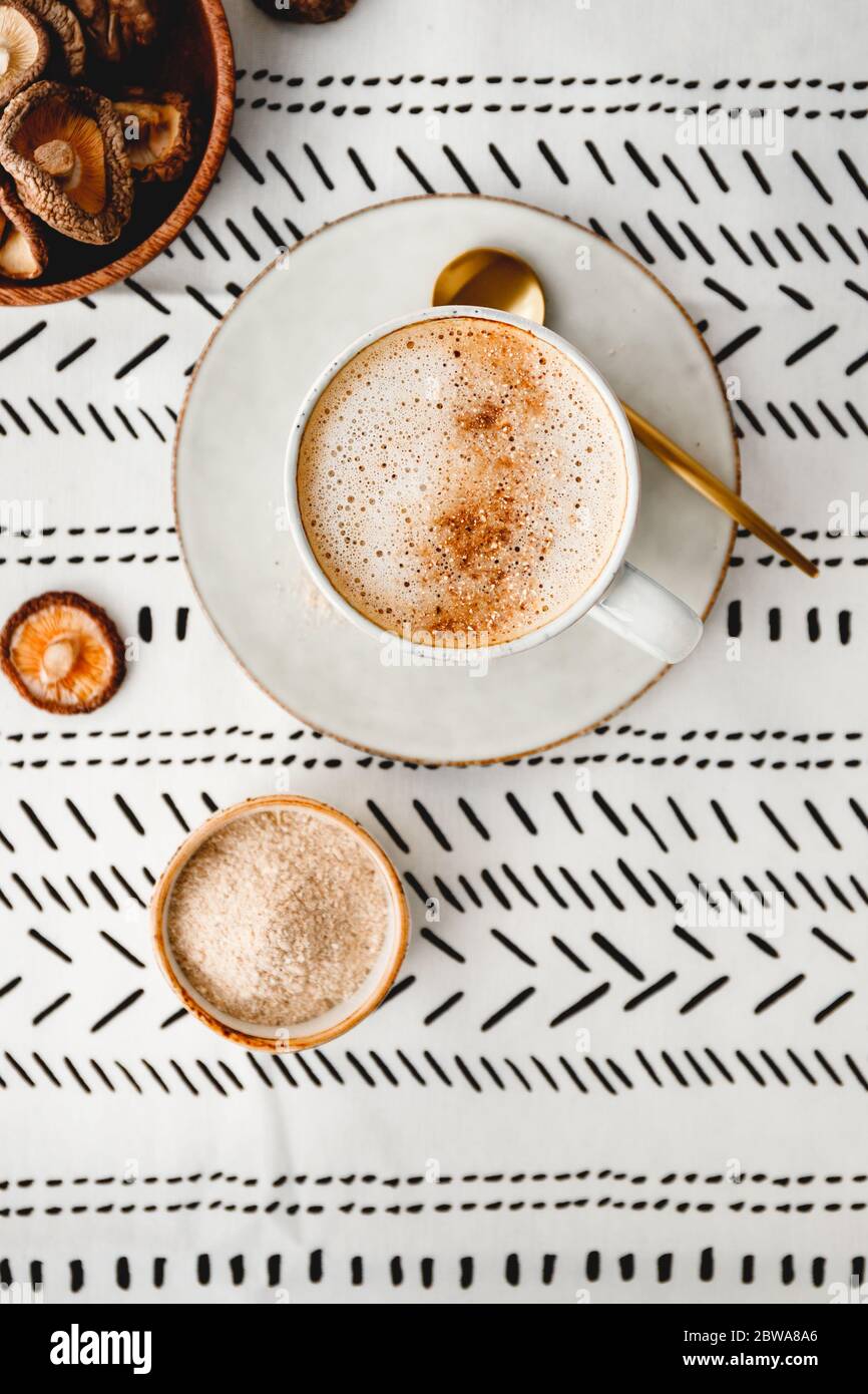 Top view of cappuccino coffee with shiitake mushroom powder. Immune and ...