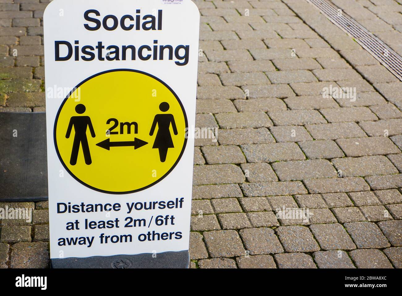 The word social distancing written on white board Stock Photo - Alamy