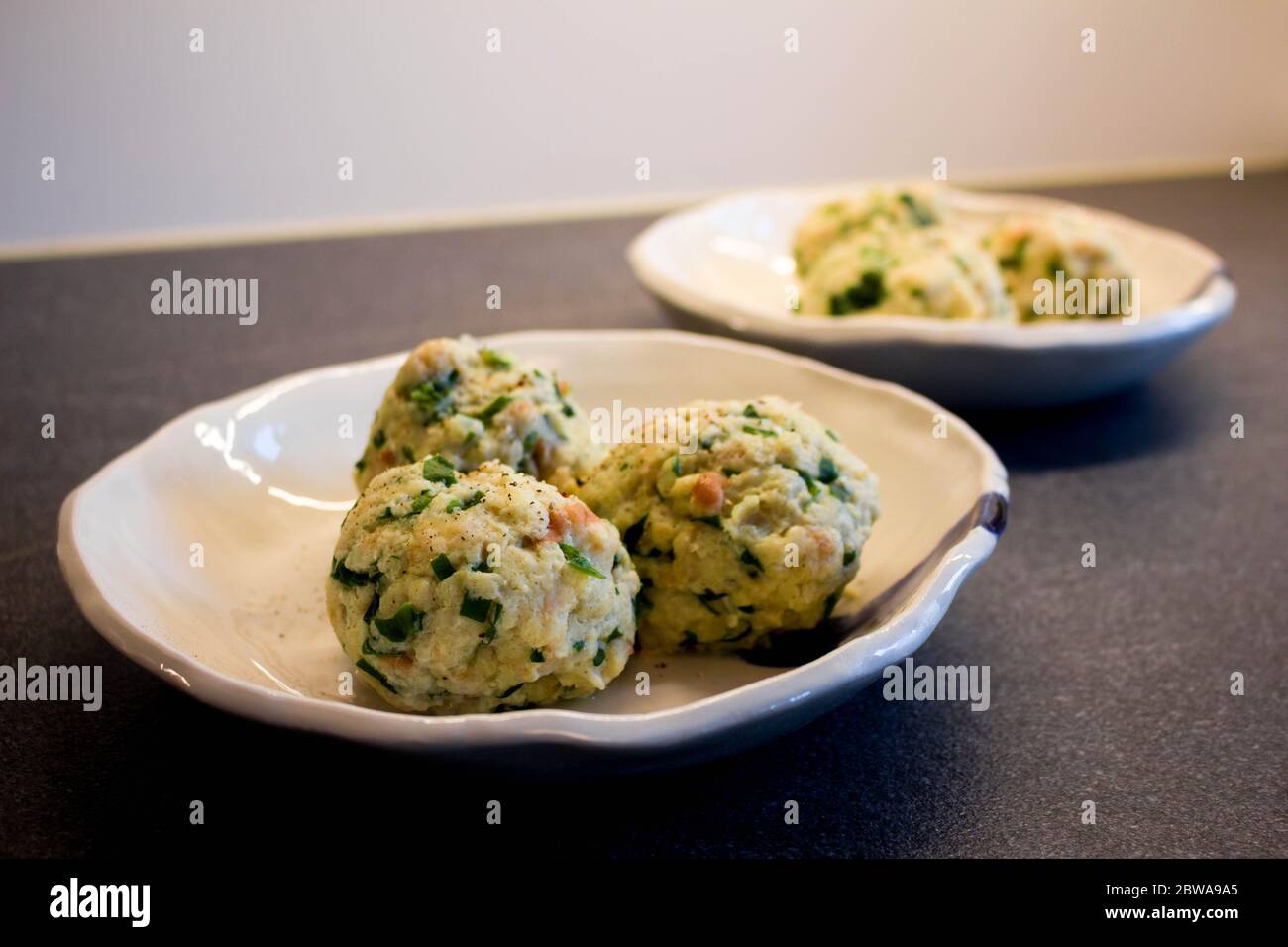 Three traditional German bread dumplings with wild garlic on handmade ...