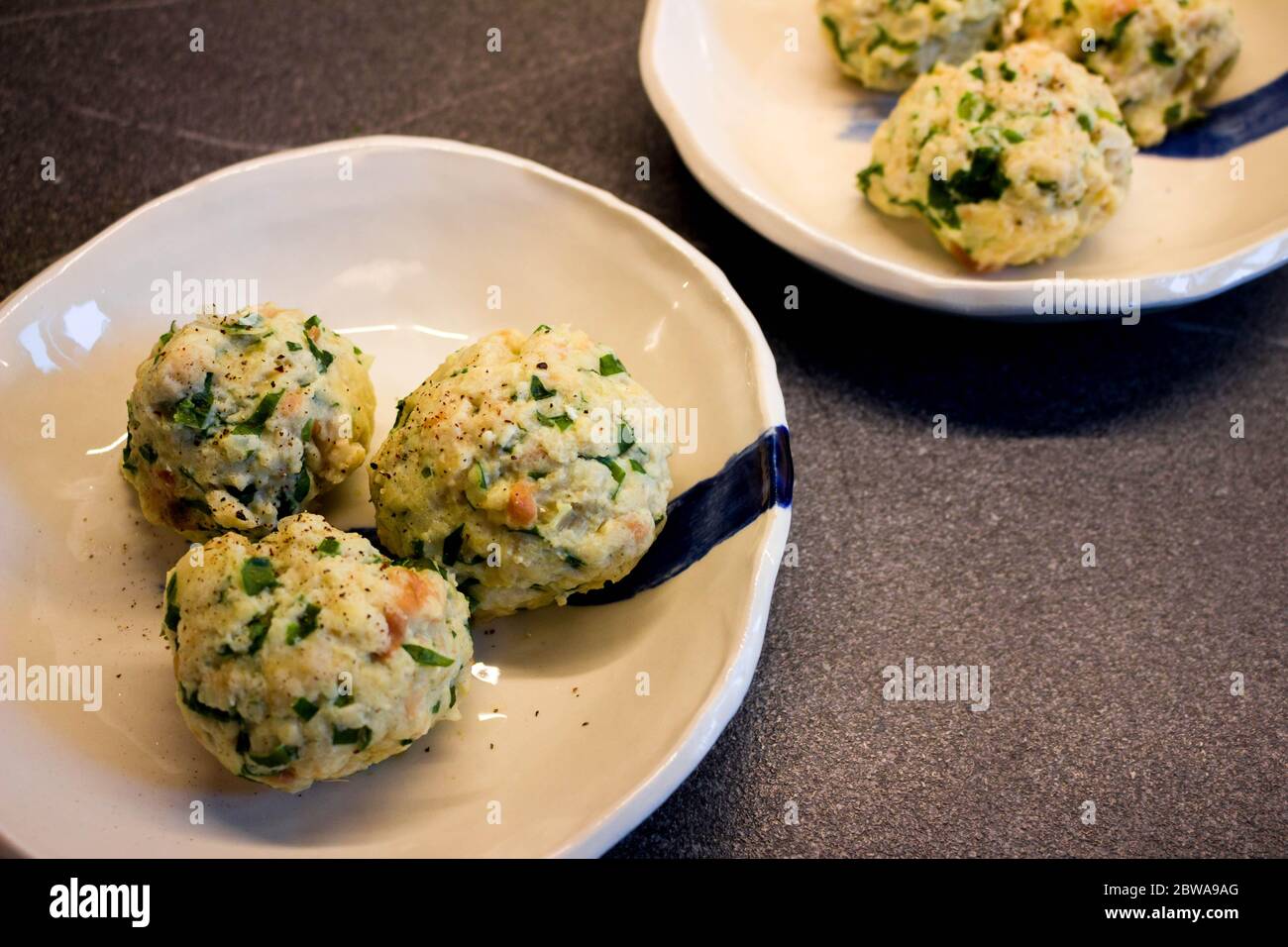 Three traditional German bread dumplings with wild garlic on handmade ...