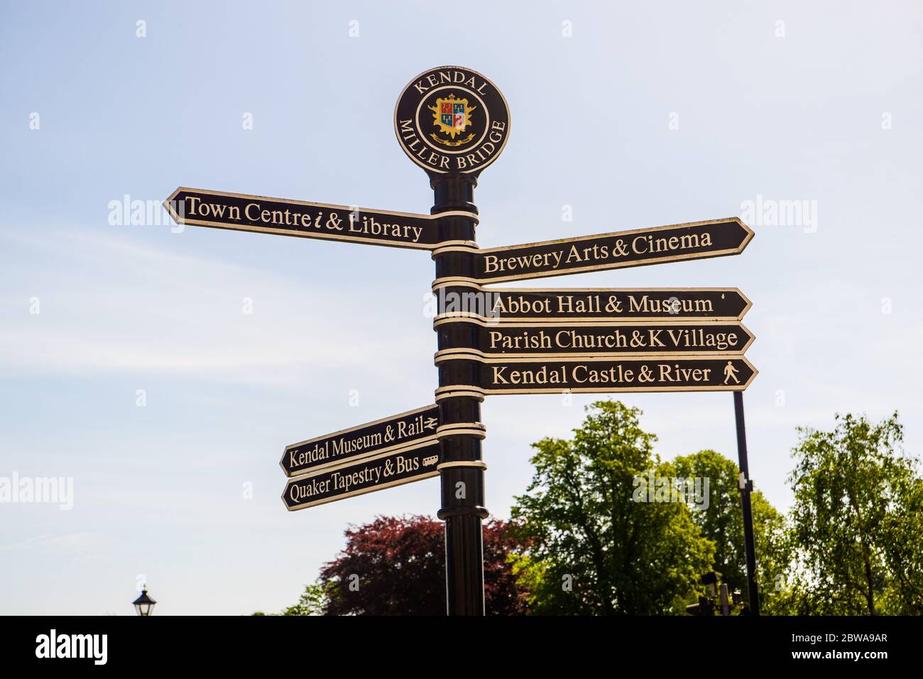 Town signpost showing directions to various places in the center of ...