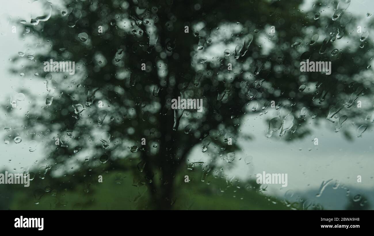 Car window is raining and the wipers are running Stock Photo - Alamy