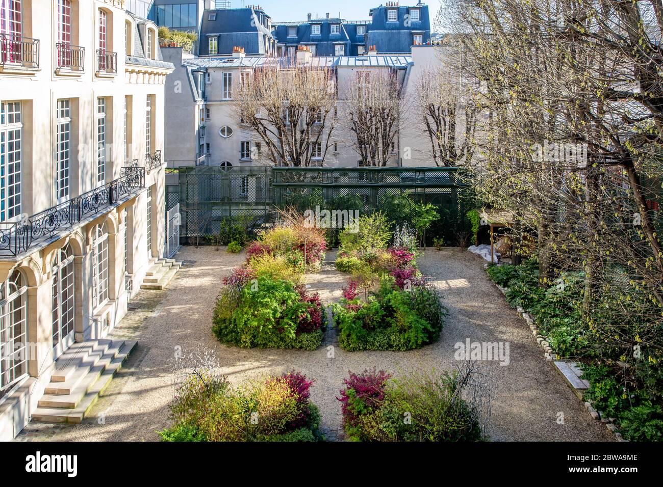Paris, France - March 25, 2020: Haussmann buildings and private garden ...