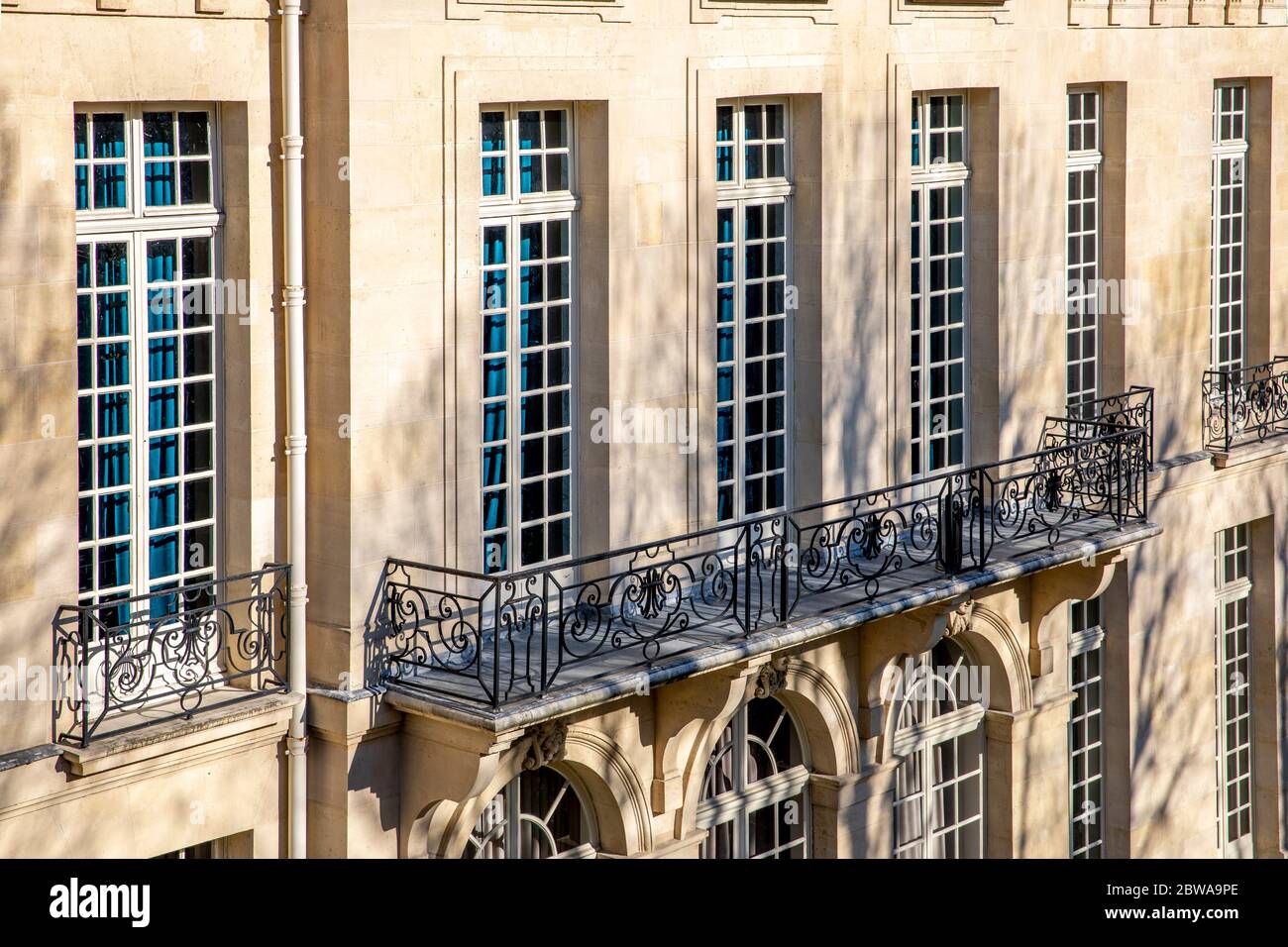 Paris, France - March 25, 2020: Haussmann buildings and private garden ...