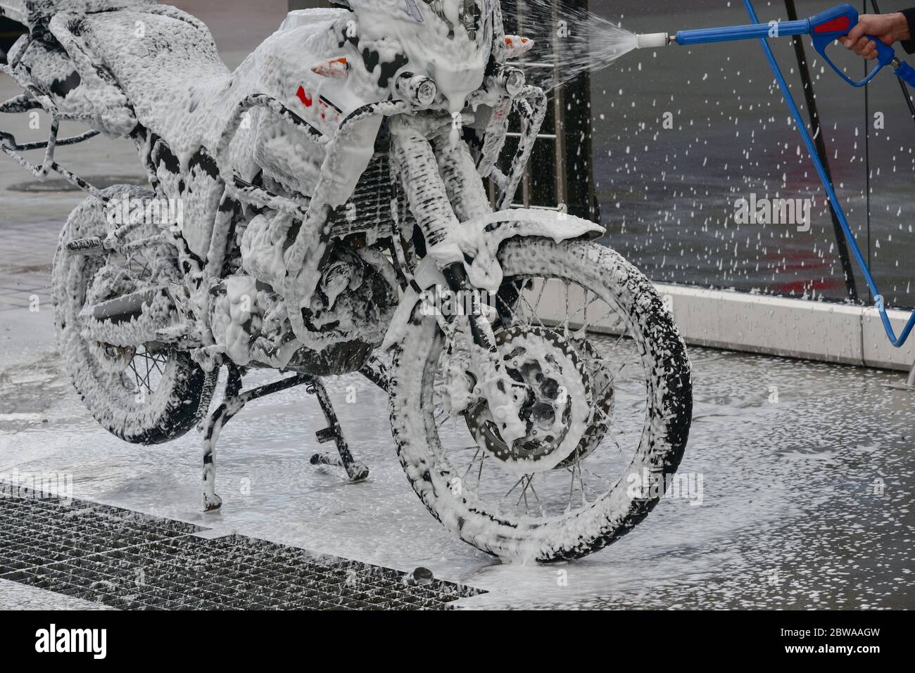Motorcycle washing with cleaning foam. Pure moto bike. Enduro motorcycle. Cleanliness of ...