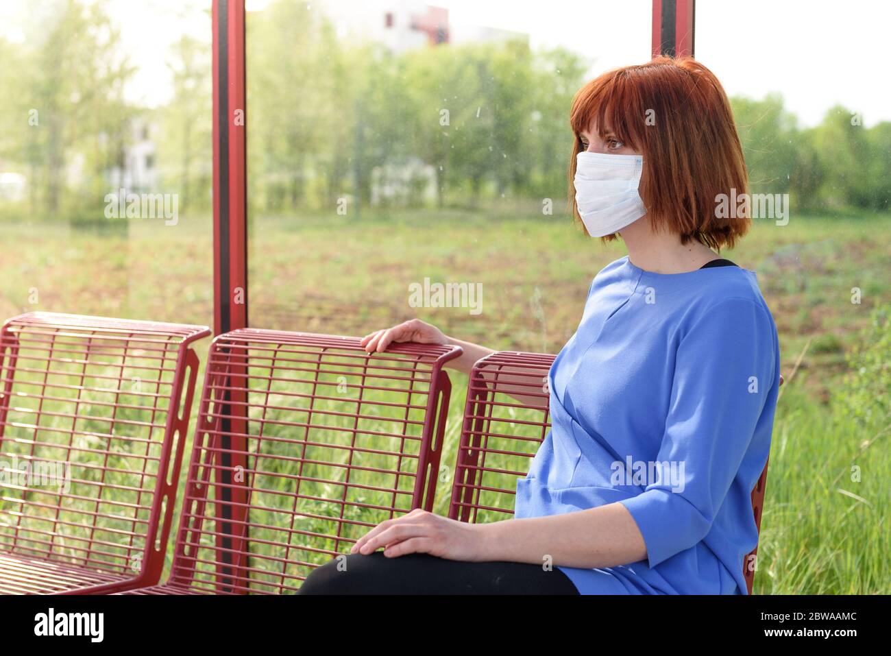 Wearing face mask at bus stop hi-res stock photography and images - Alamy
