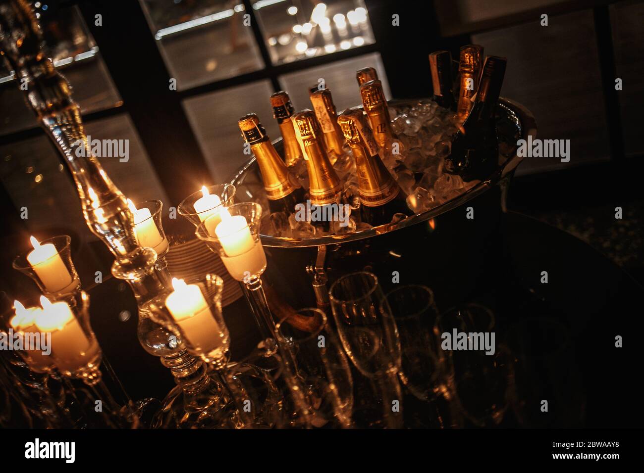 Champagne in ice and candles Stock Photo - Alamy