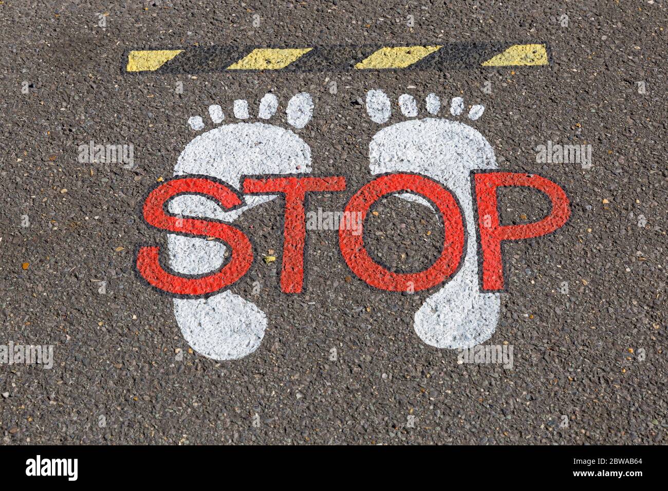 Poole, Dorset UK. 31st May 2020. Stop sign with footprints on pavement ...
