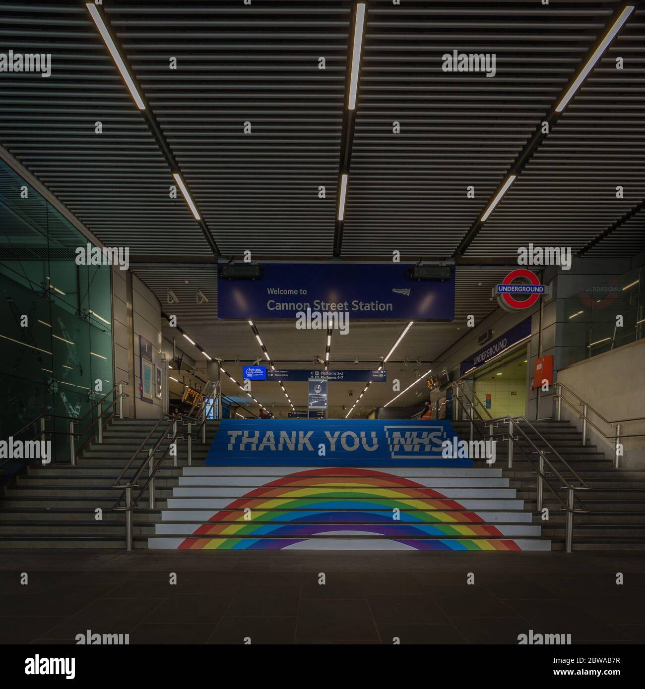 A quiet train station with a rainbow tribute message to the NHS staff ...