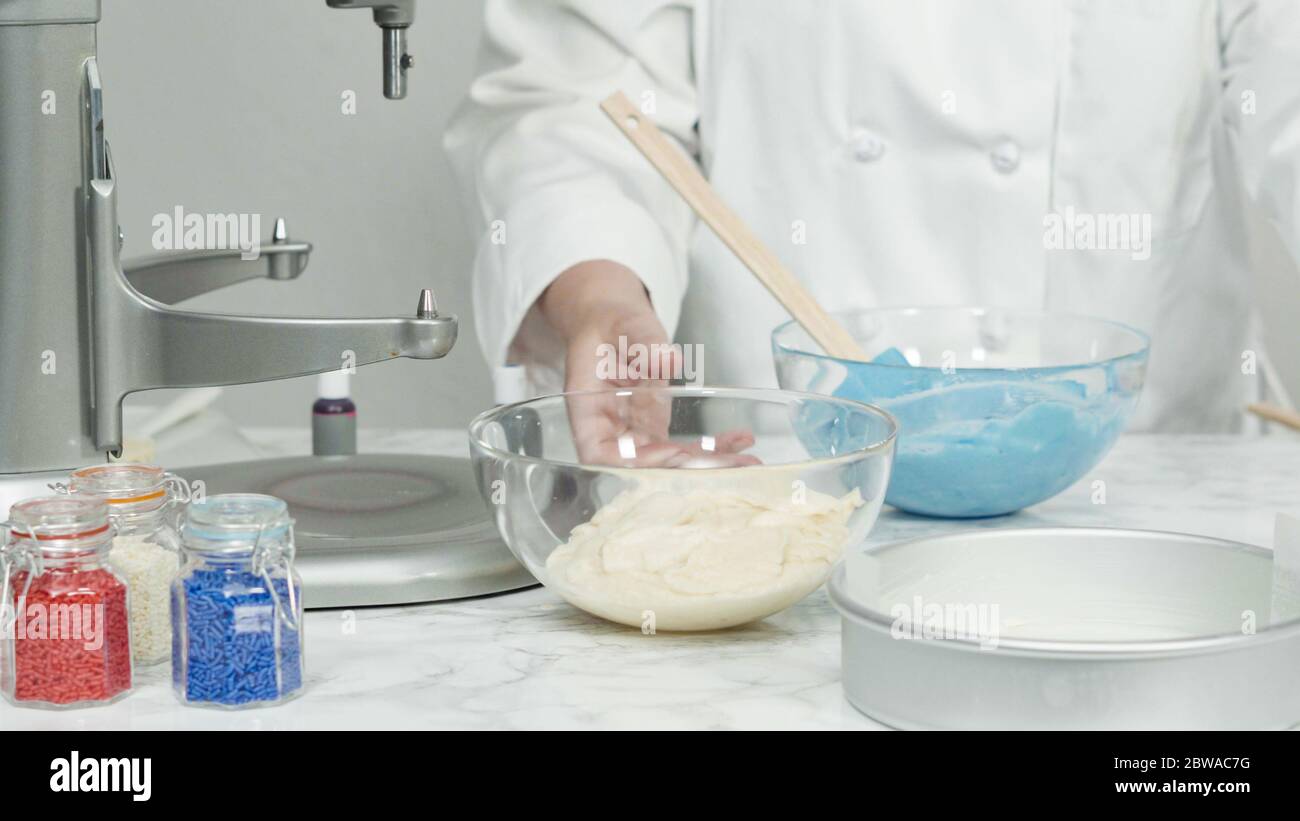 Step by step. Mixing food coloring into a cake batter to bake a three ...