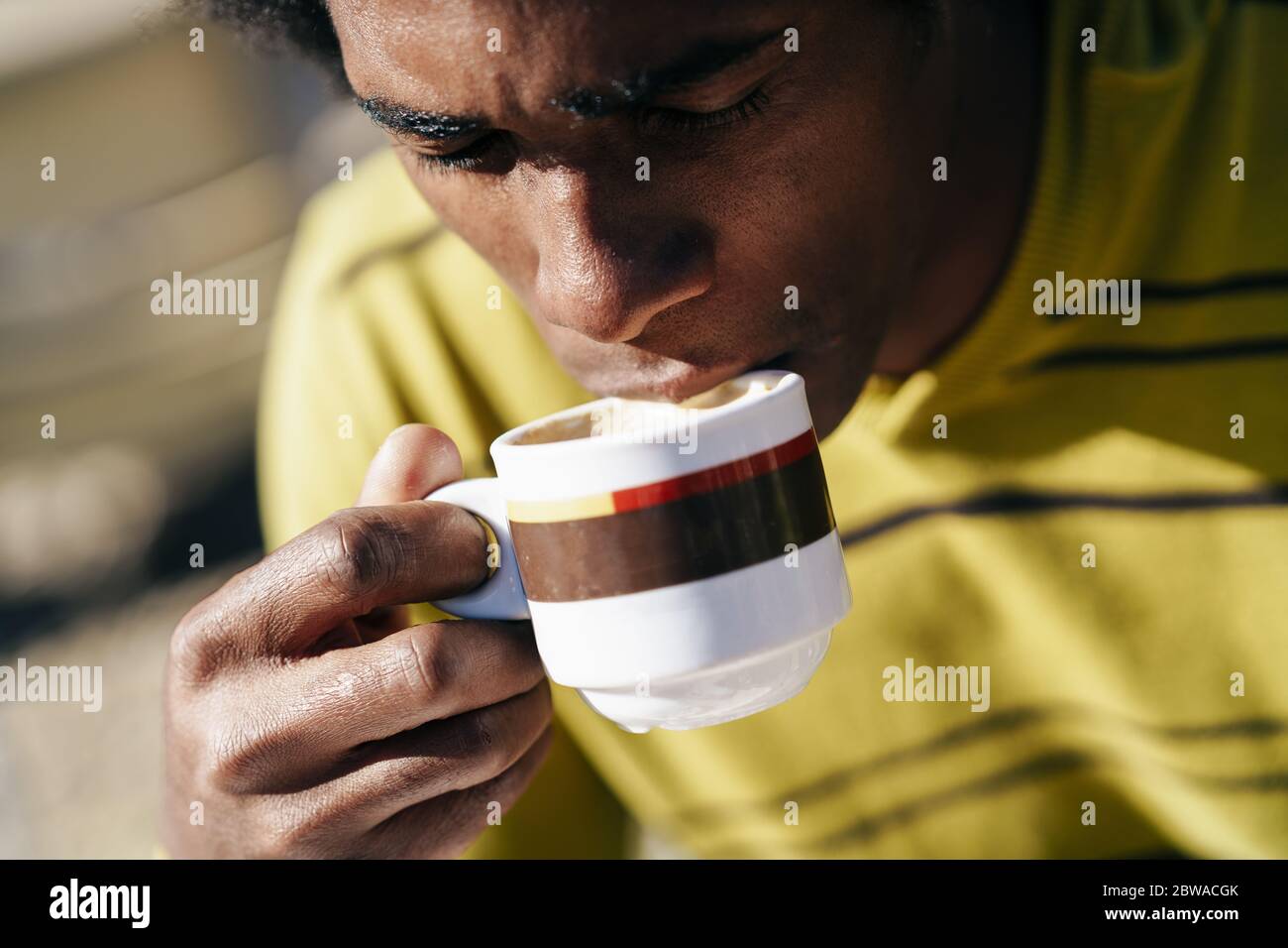 African guy holding coffee mug hi-res stock photography and images - Alamy