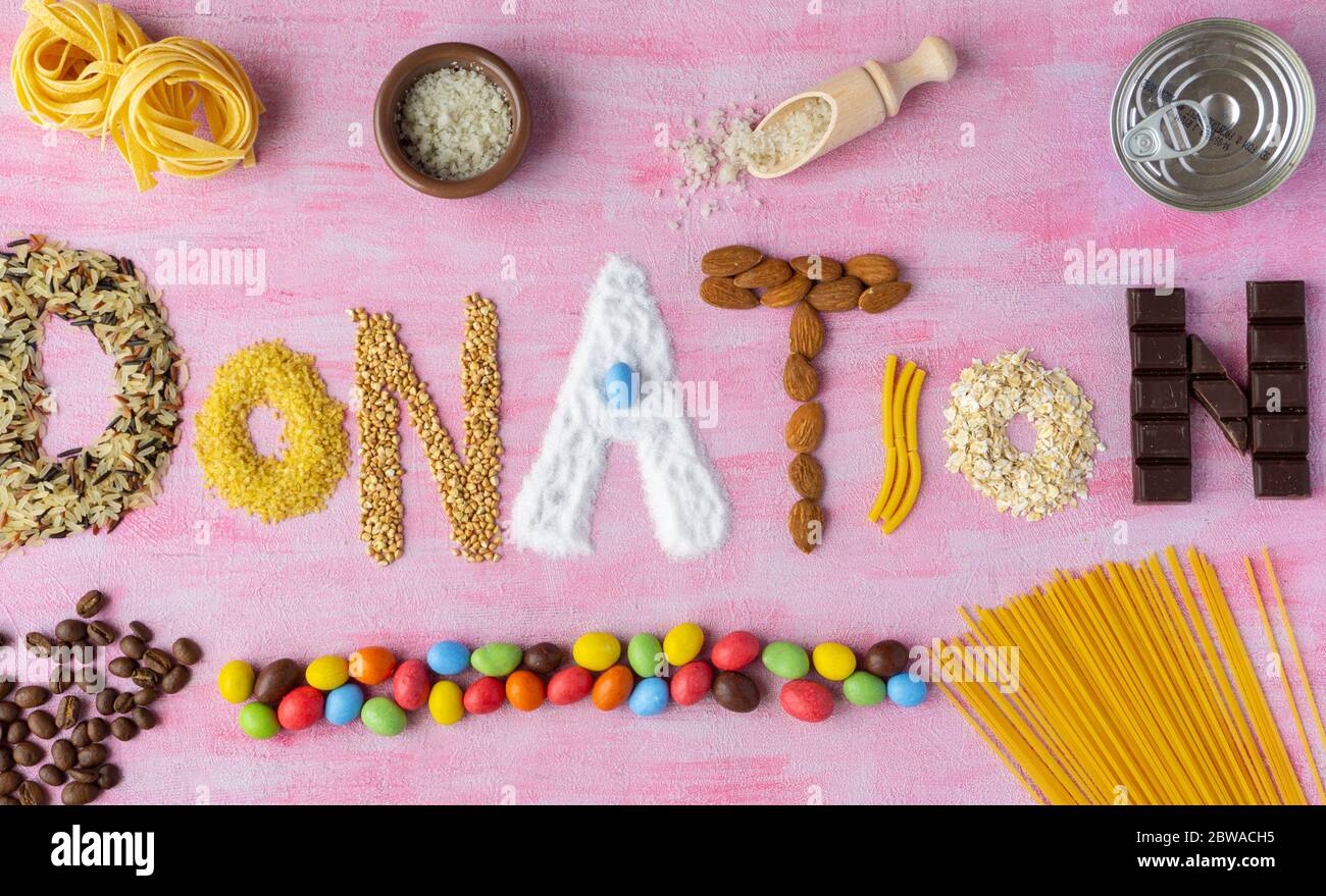The word donation made of different type of groats, nuts, chocolate and ...