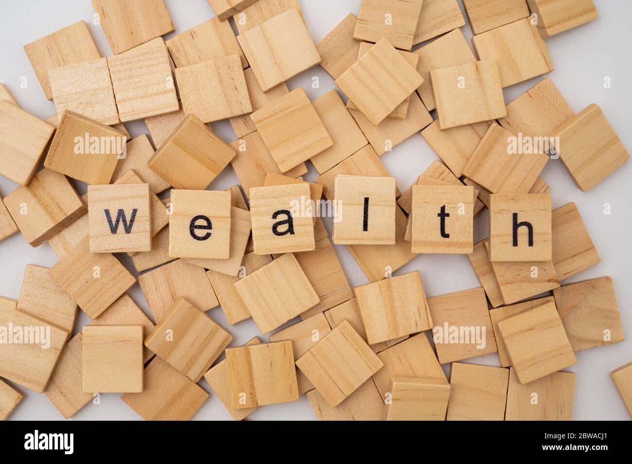 Wooden letter tiles spelling the word WEALTH Stock Photo - Alamy