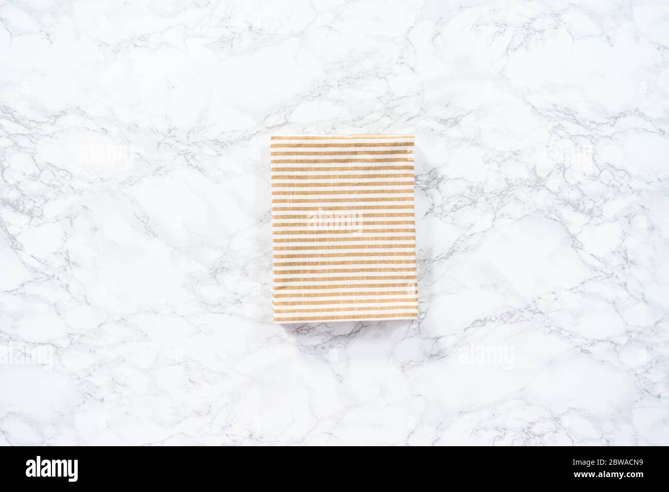 Flat lay. Kitchen towels with white and beige stripes on the marble ...