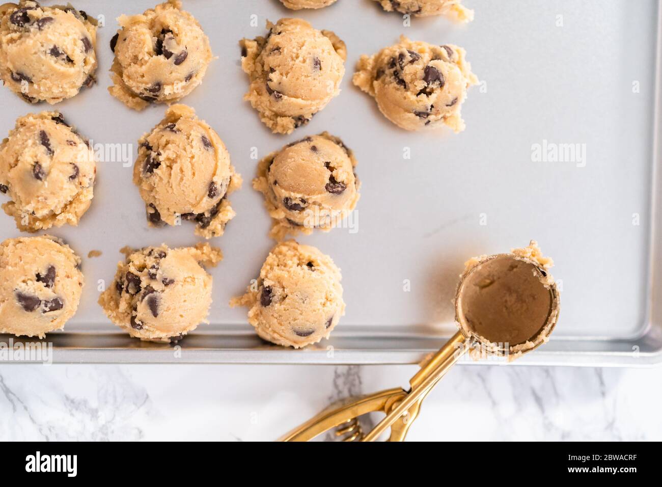 Homemade chocolate chip cookies dough scoops on a baking sheet Stock ...