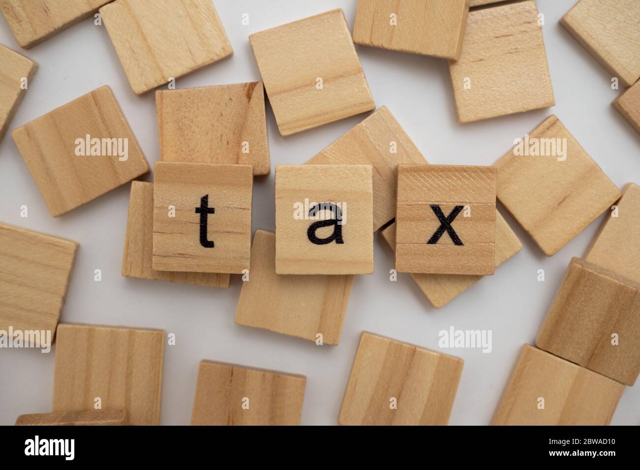 Wooden letter tiles spelling the word TAX Stock Photo - Alamy