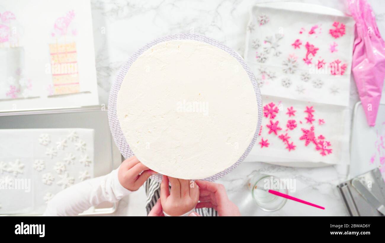 Flat lay. Step by step. Decorating round funfetti cake with pink and ...