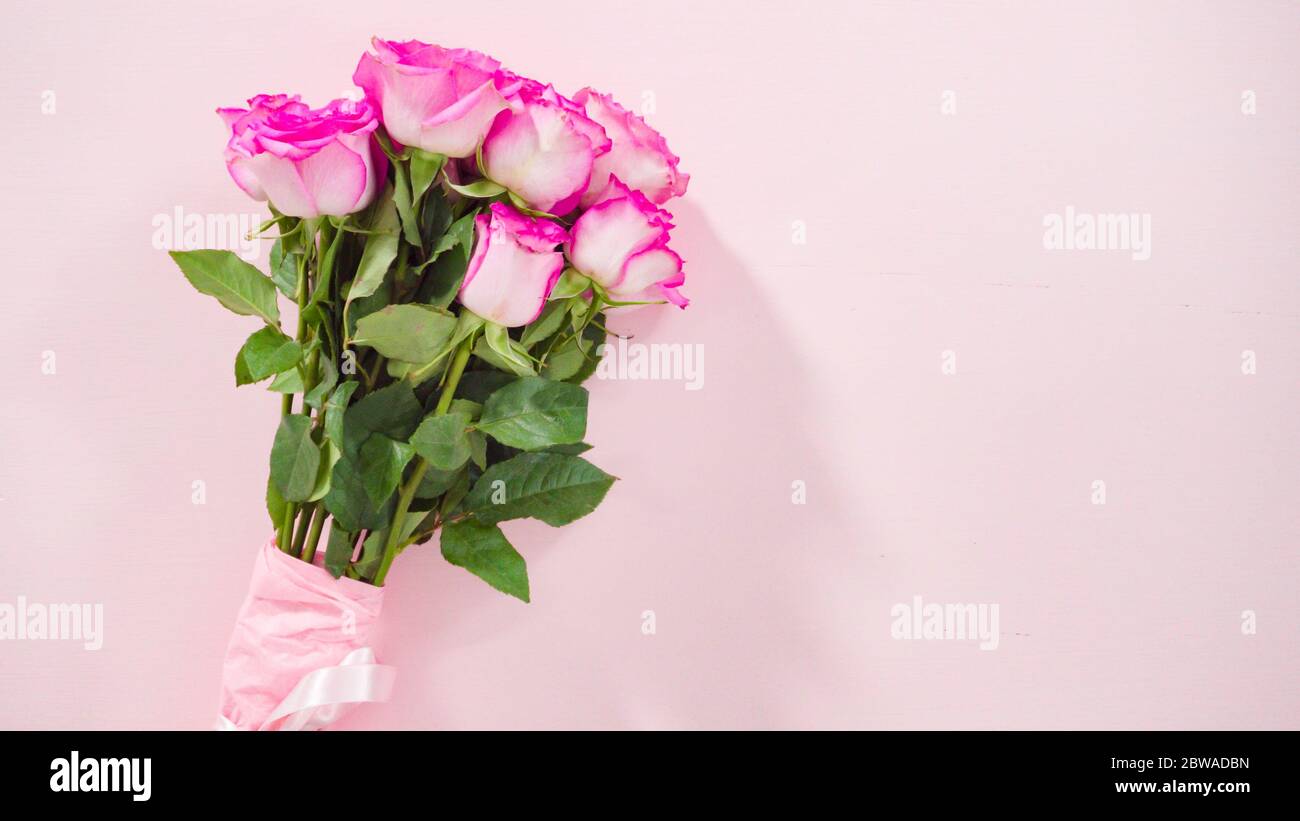 Flat lay. Step by step. Florist arranging a bouquet from pink roses ...