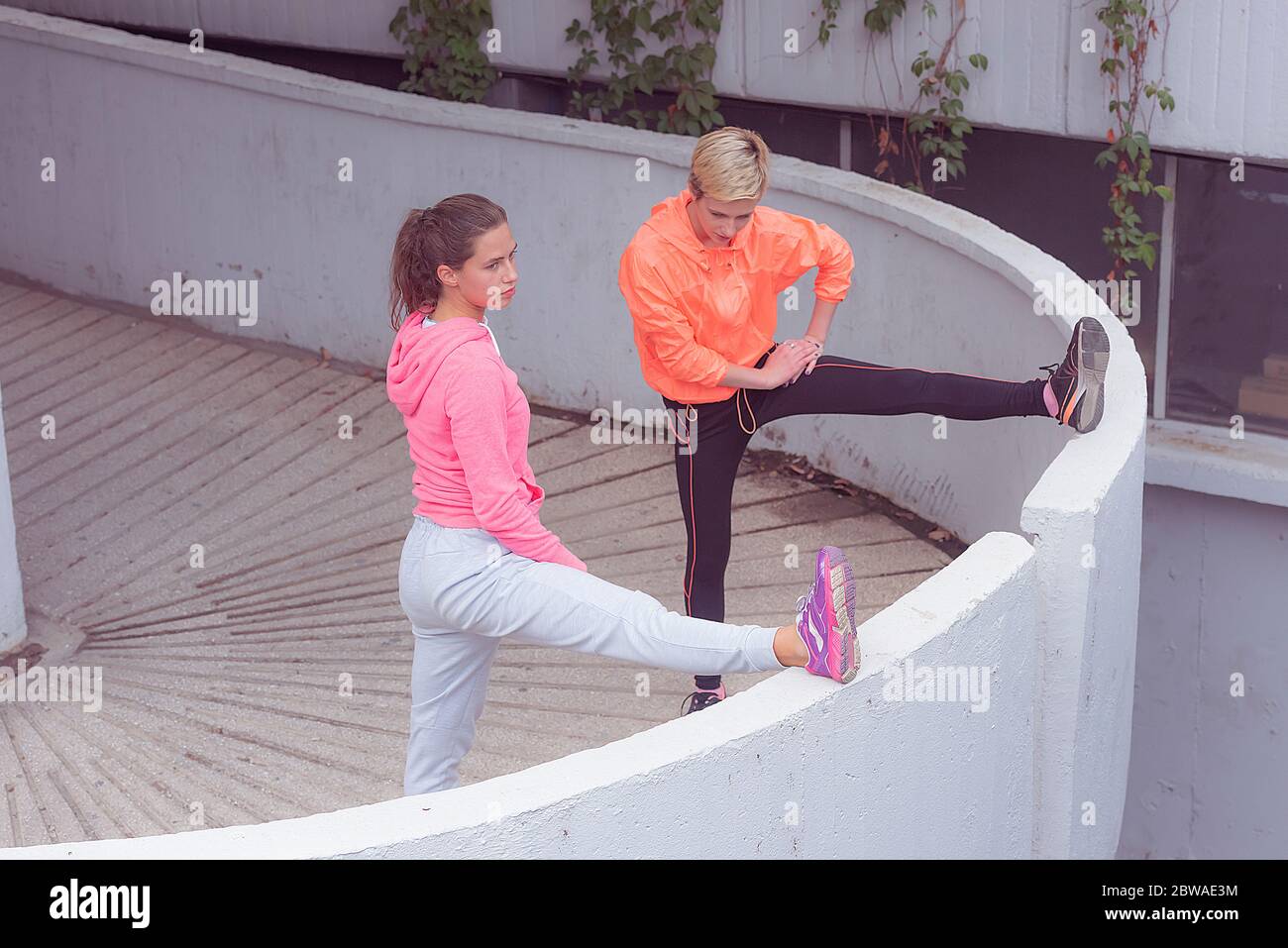Two healthy young female sporty women prepairing for running in morning ...