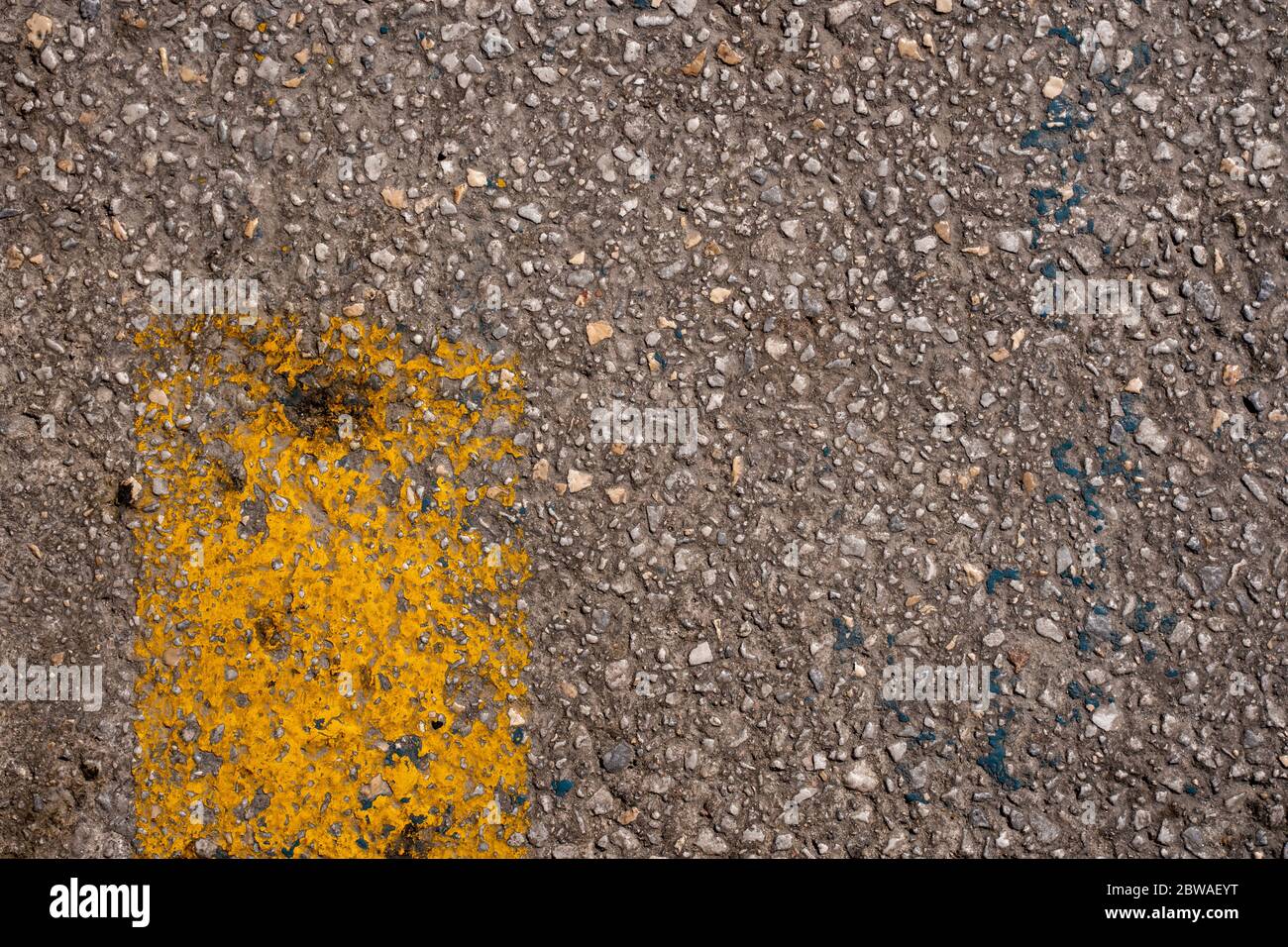 Asphalt road texture with worn yellow paint. Close-up. Top view Stock ...