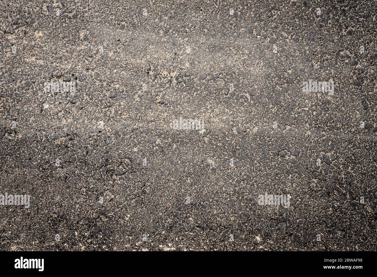 Asphalt road texture covered in sand Stock Photo - Alamy
