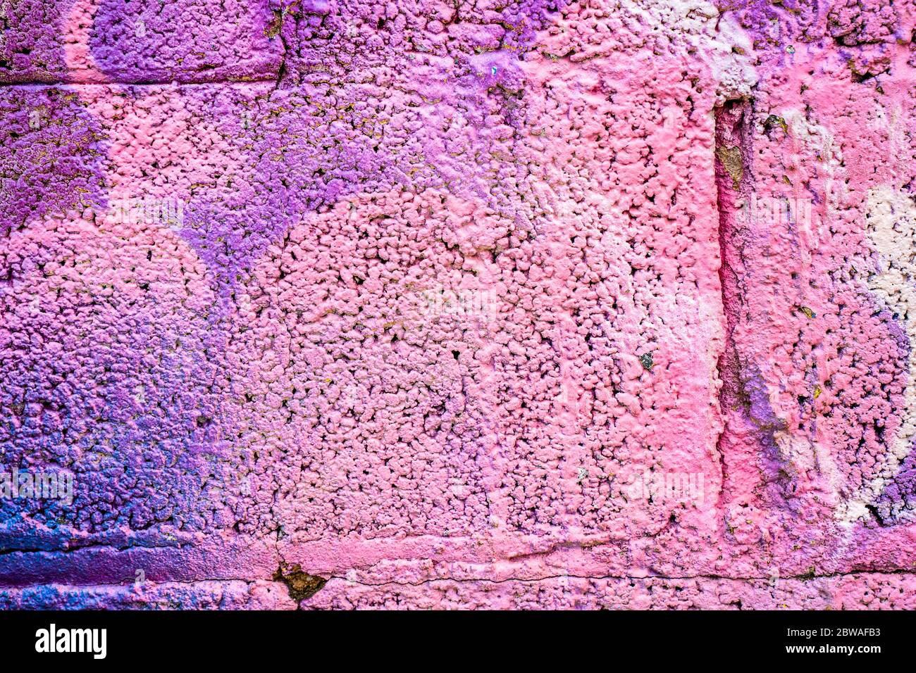 Pink gradient graffiti close-up on concrete block wall texture. Street ...
