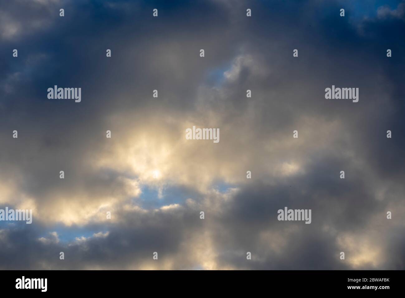 Gray clouds covering the sun during sunset. Sky background Stock Photo ...