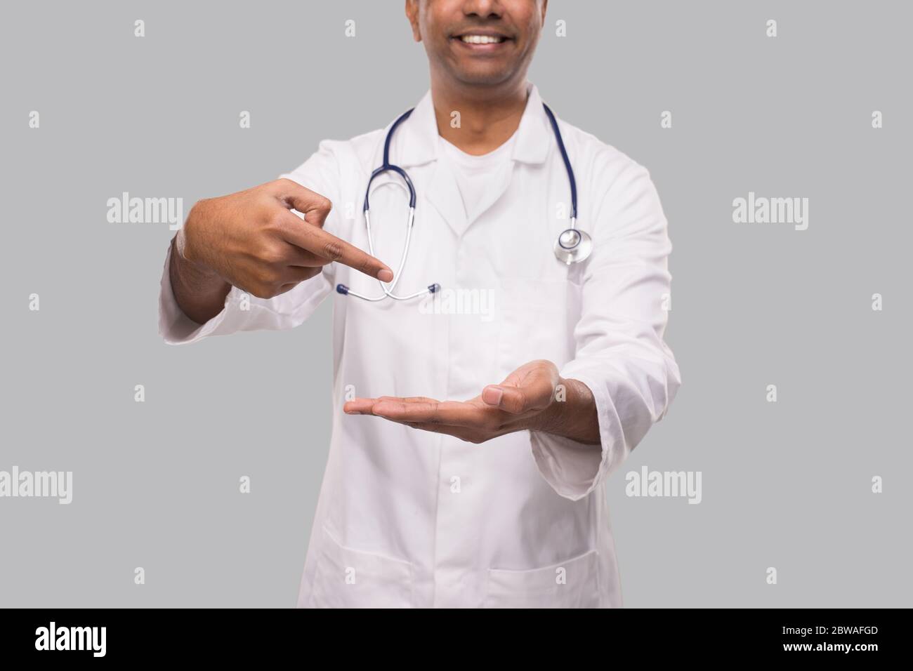 Doctor Pointing at Empty Open Hand in front of Chest Close Up Isolated ...