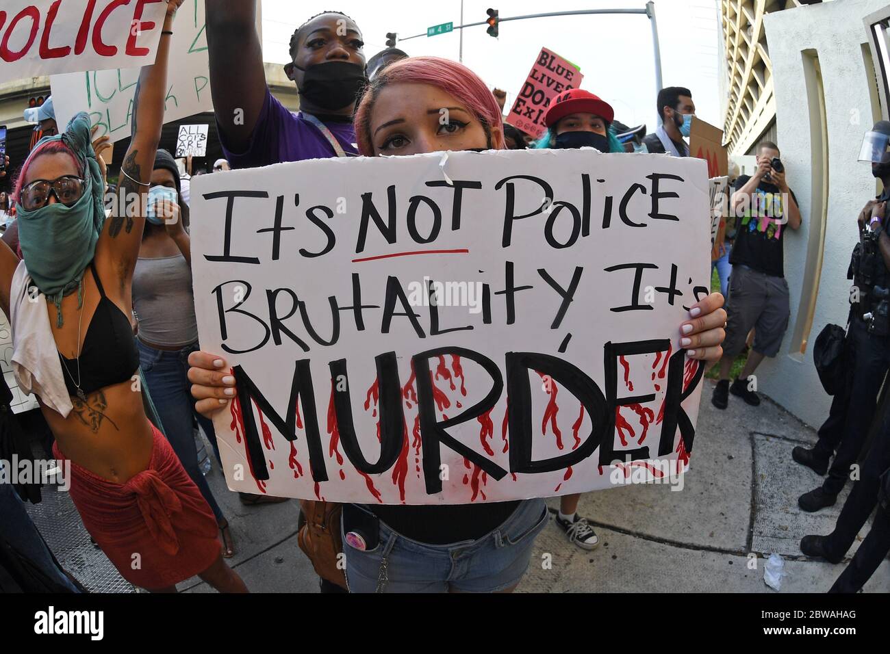 Miami, FL, USA. 30th May, 2020. Protestors are seen signs as they ...