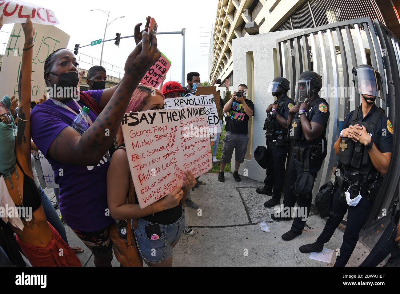 Miami, FL, USA. 30th May, 2020. Protestors are seen signs as they ...