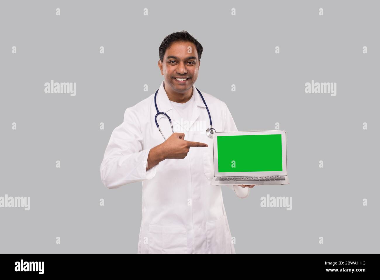 Doctor Pointing at Laptop Green Screen Watching in Camera Isolated ...