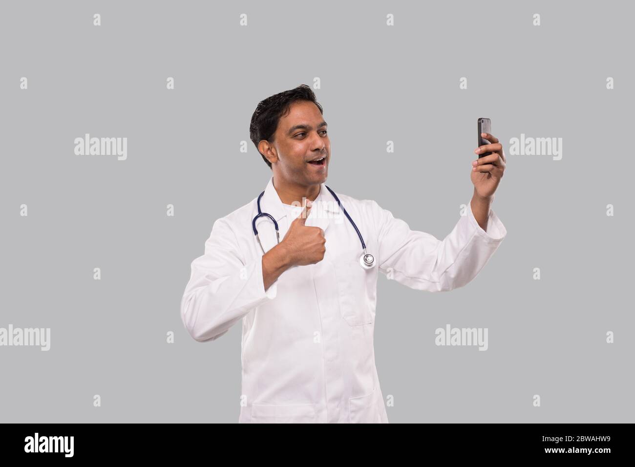 Doctor Having Video Call on Phone Showing Thumb Up Isolated. Indian Man ...