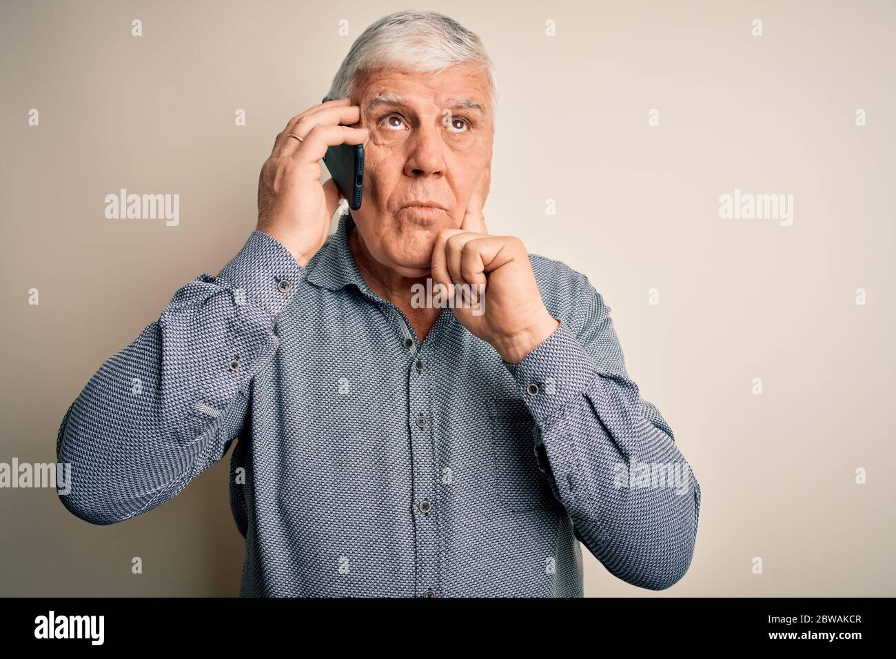 Senior hoary man having conversation talking on the smartphone over ...