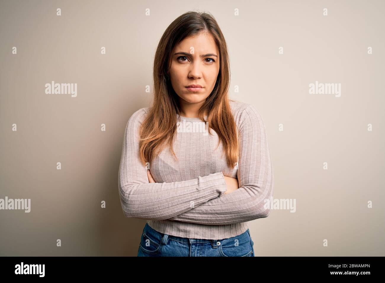 Beautiful young woman standing casual over isolated background skeptic ...
