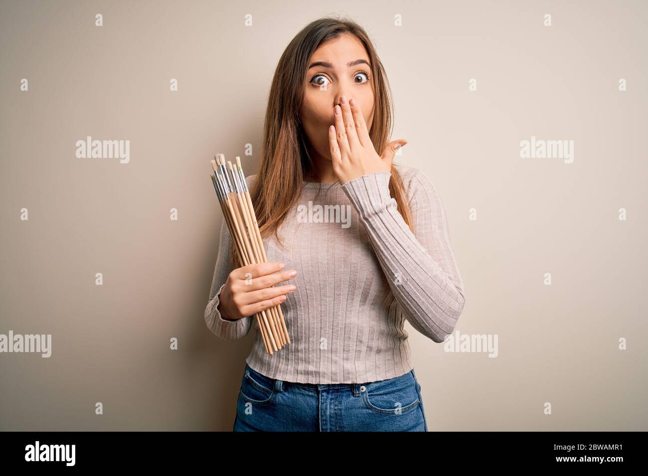 Young painter artist woman painting using paintbrush over isolated ...