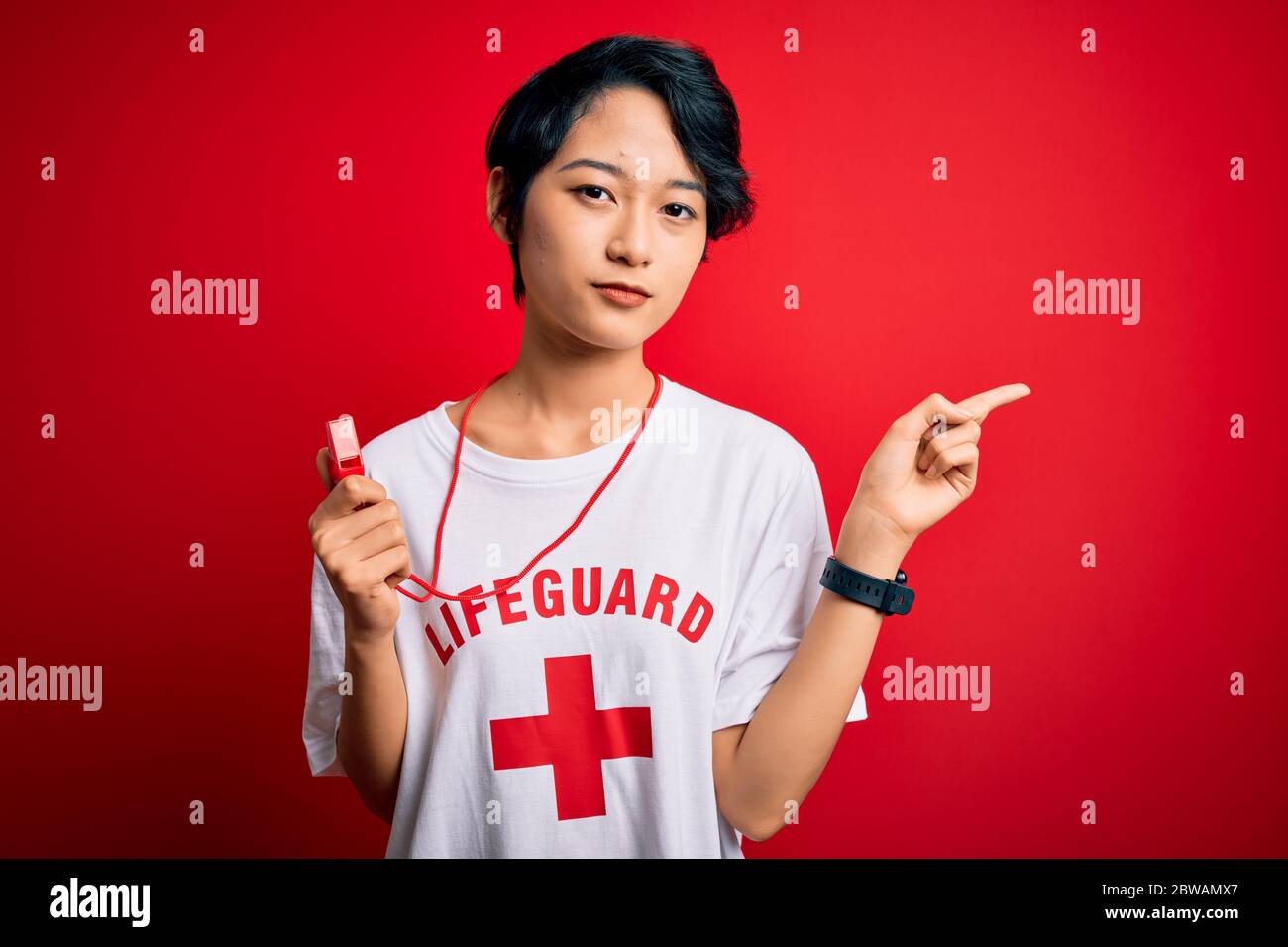 Young beautiful asian lifeguard girl wearing t-shirt with red cross ...