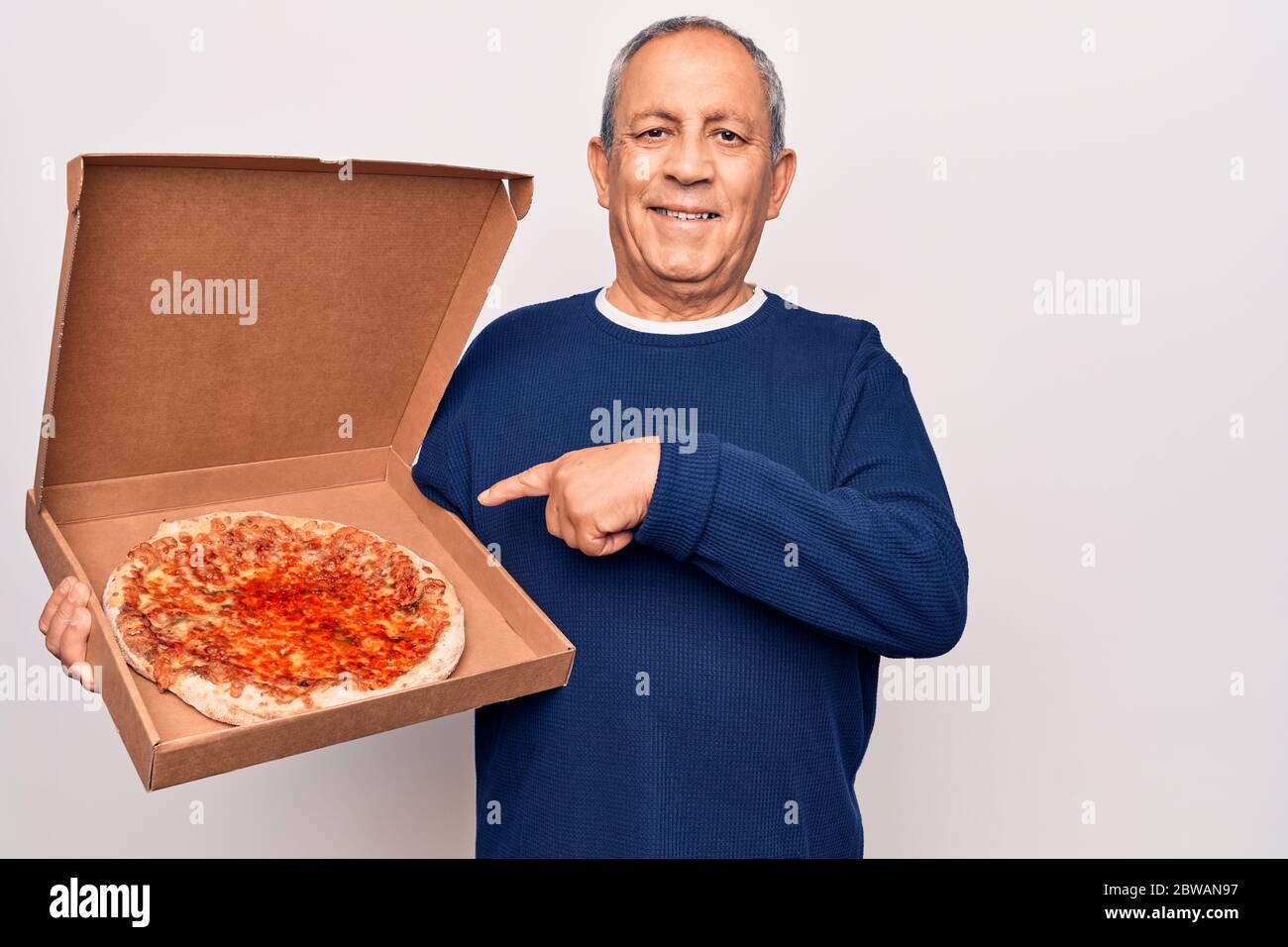 Senior man with grey hair holding delivery box of italian pizza smiling ...