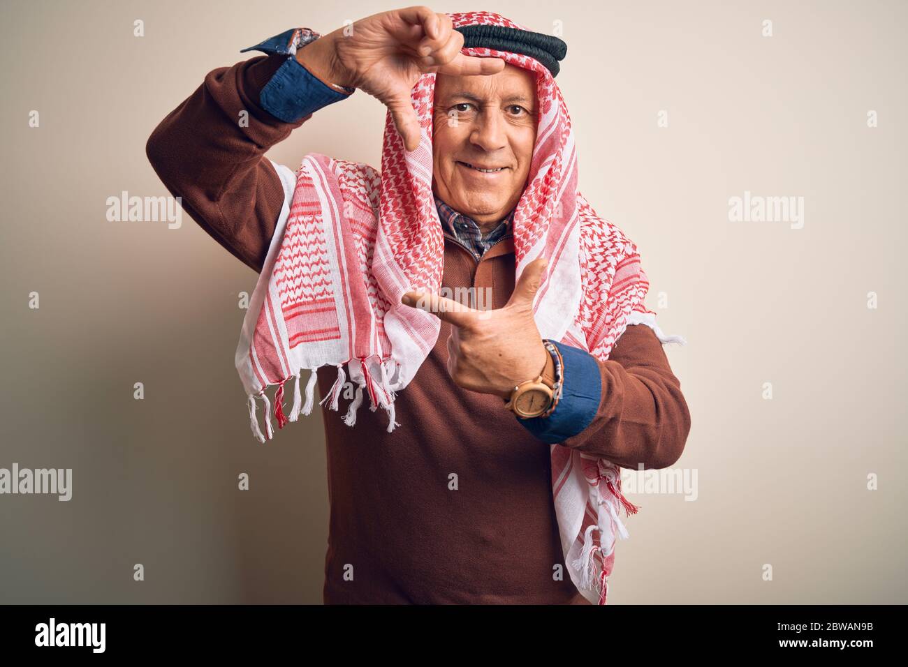 Senior handsome arab man wearing keffiyeh standing over isolated white ...