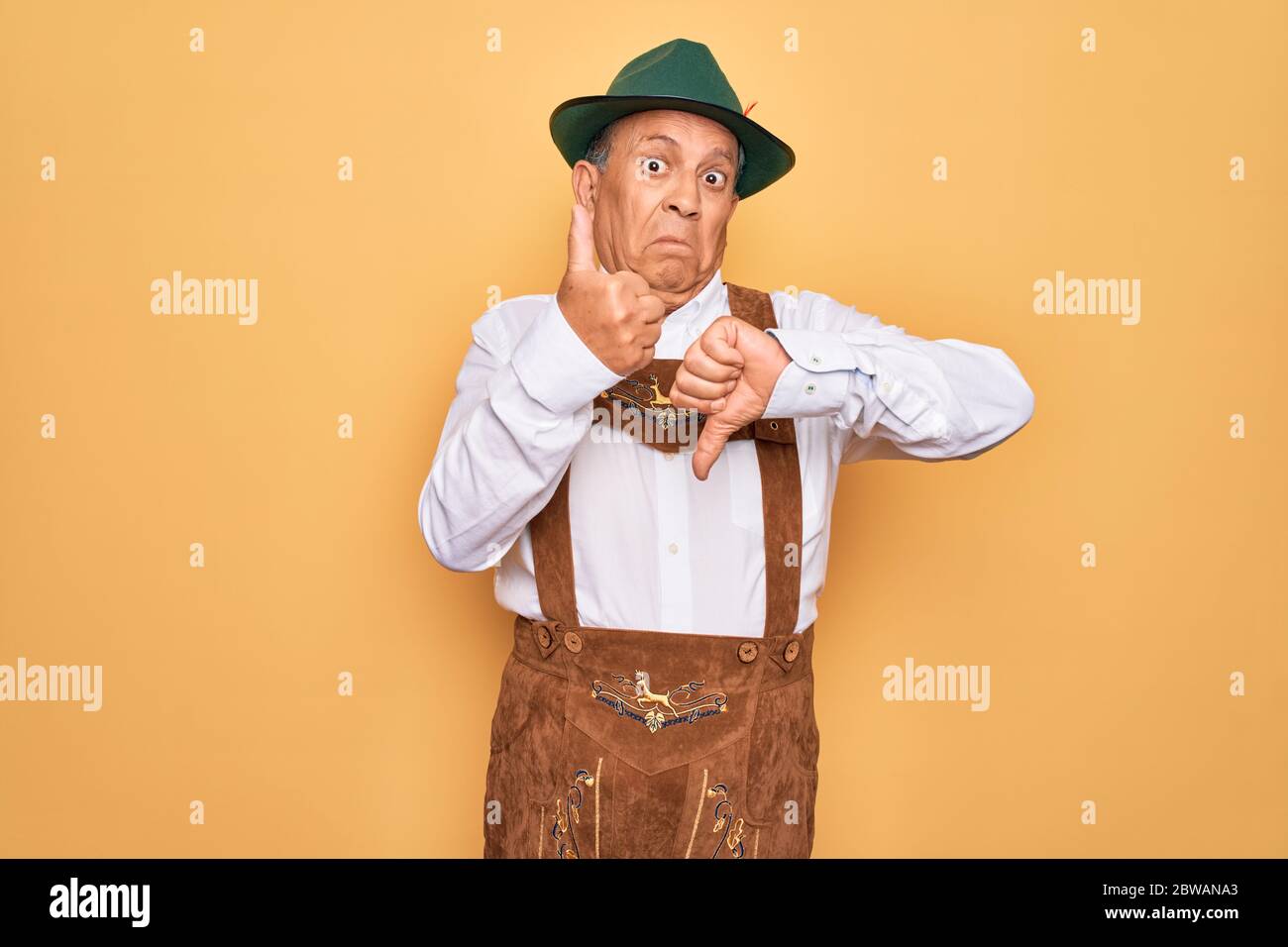 Senior grey-haired man wearing german traditional octoberfest suit over ...