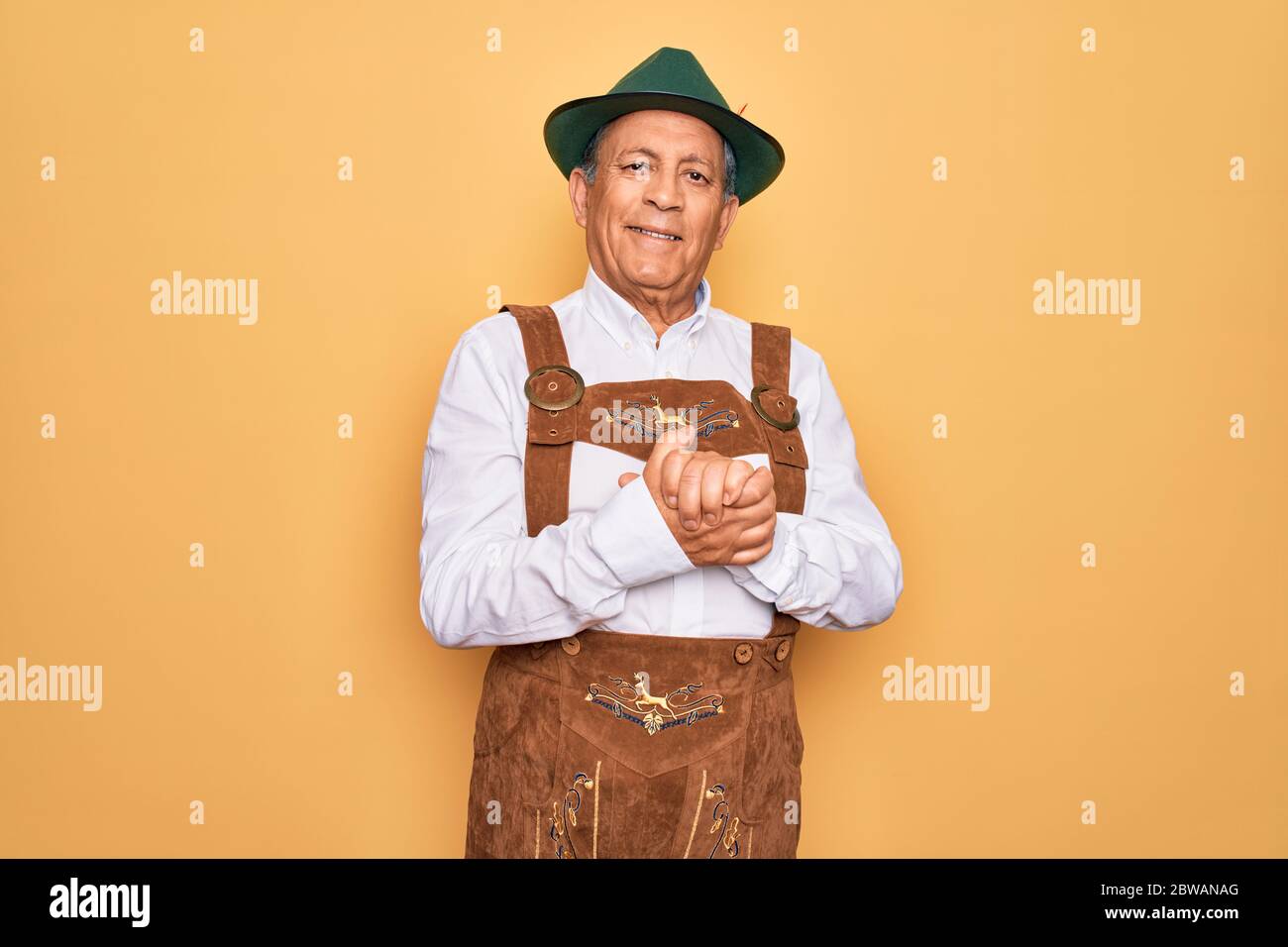 Senior grey-haired man wearing german traditional octoberfest suit over ...