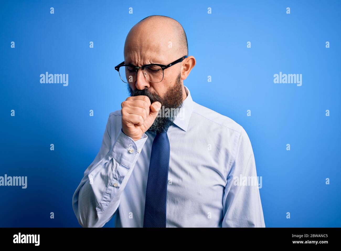 Handsome business bald man with beard wearing elegant tie and glasses ...