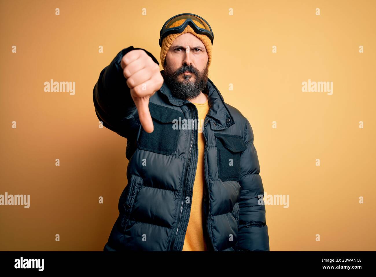 Handsome skier bald man with beard skiing wearing snow sportswear and ...