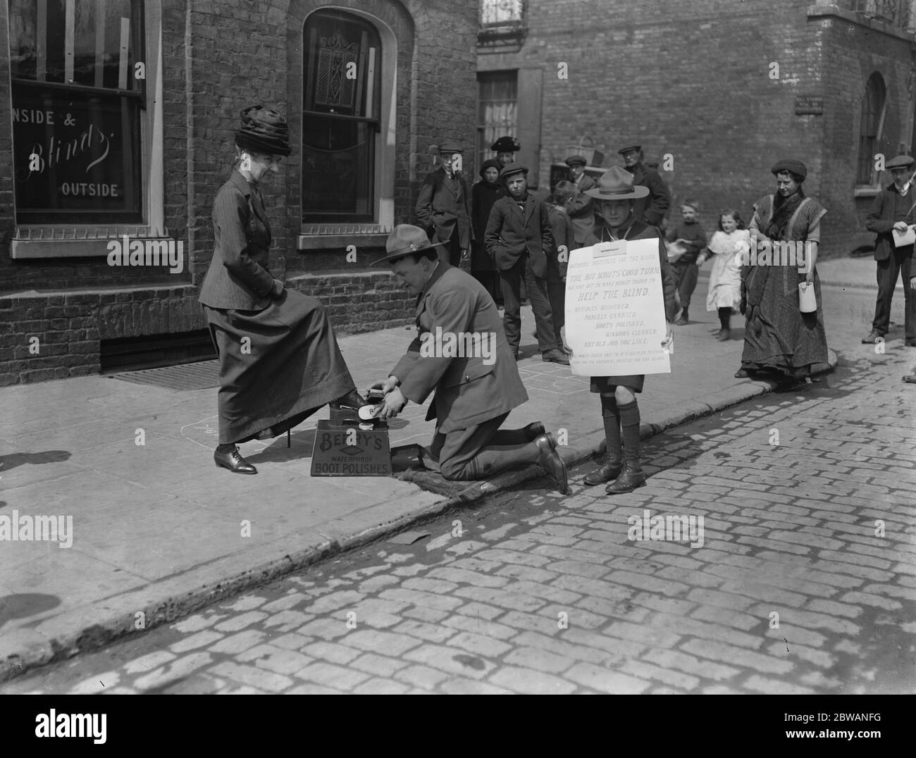 Boy scouts help the Blind Reverend Everard Digby cleaning boots Stock ...